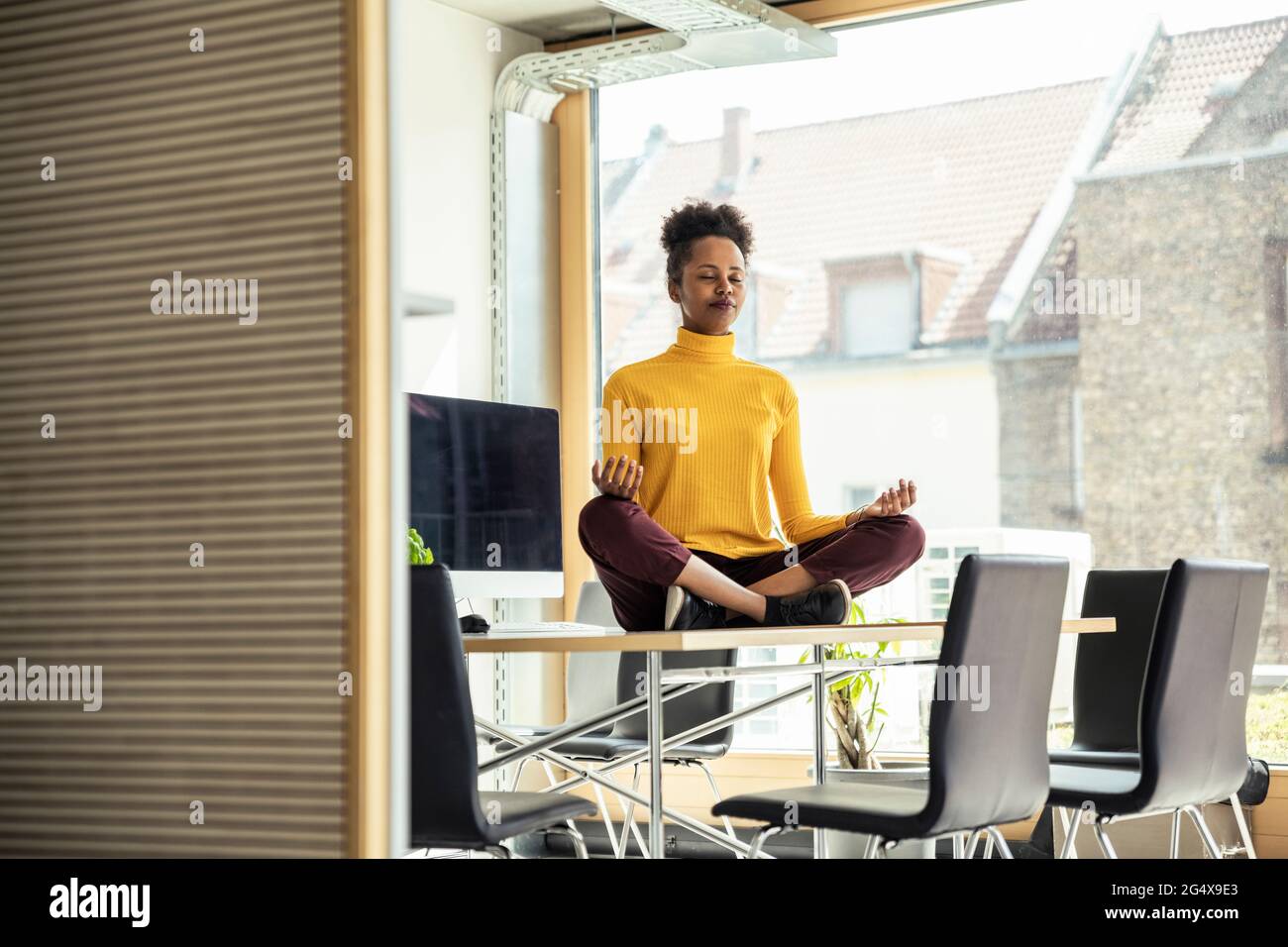 Business woman meditating on desk hi-res stock photography and images ...