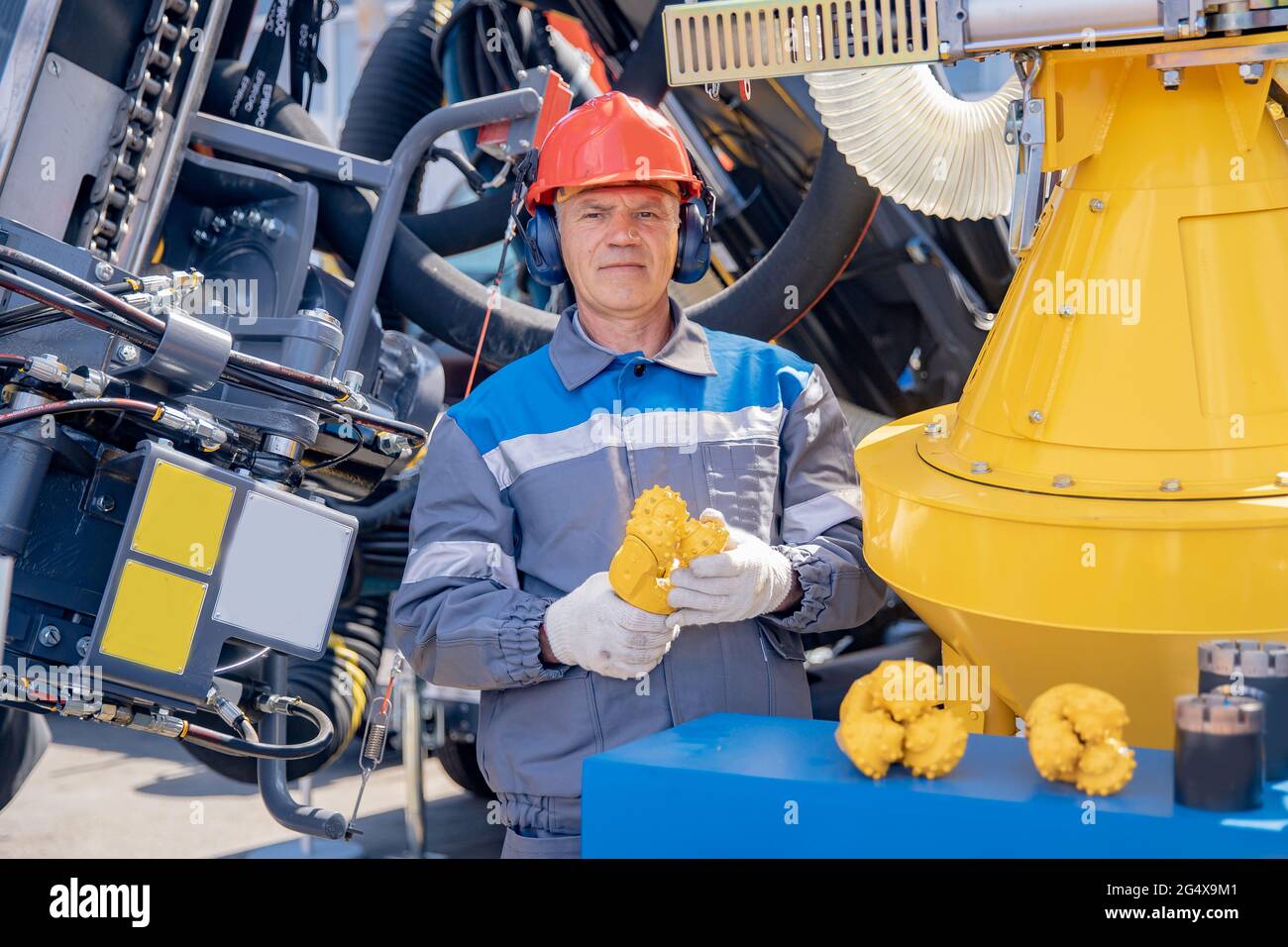Drilling engineer holds steel bit for geological exploration for oil ...