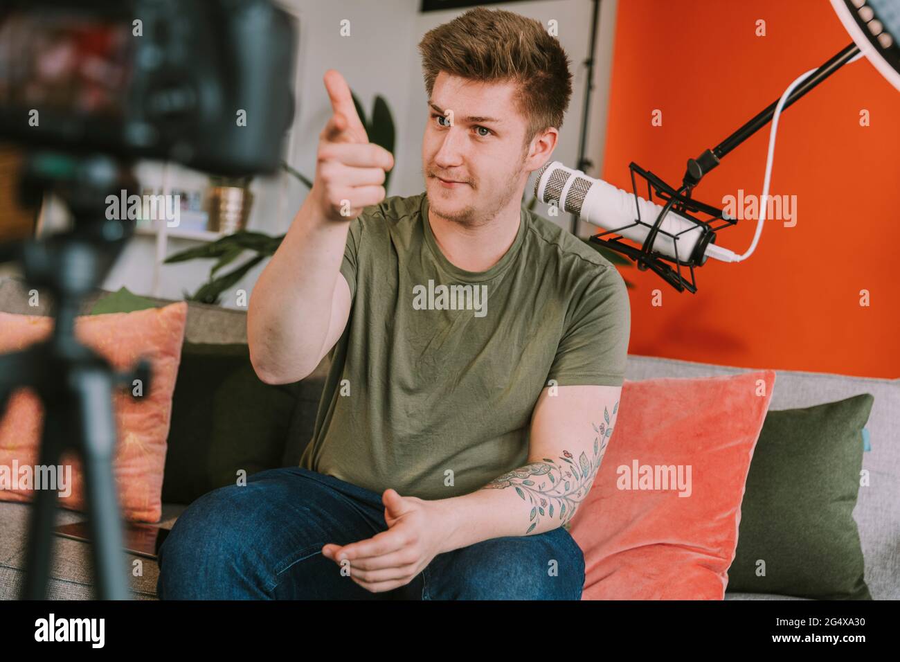 Male influencer gesturing while vlogging at home Stock Photo - Alamy