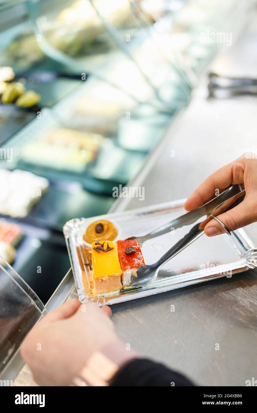 Female owner with cake in tray at bakery Stock Photo - Alamy