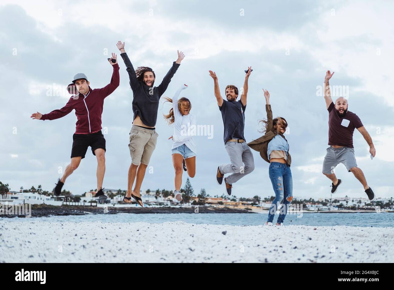 Happy group friends jumping full hi-res stock photography and images ...