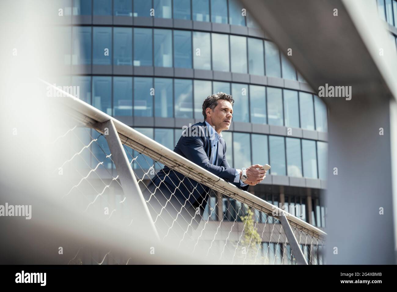 Pensive businessman leaning on railing hi-res stock photography and ...