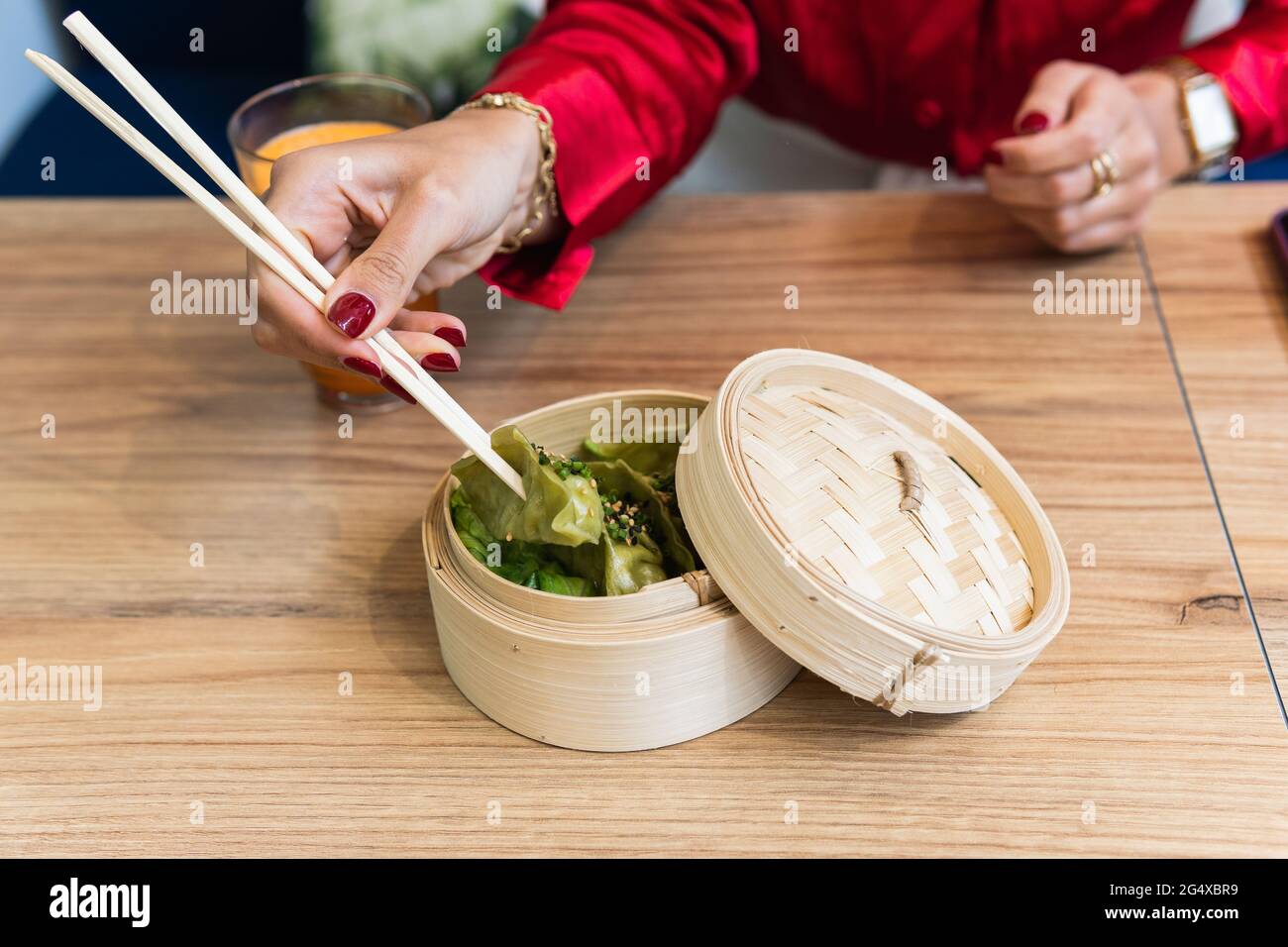 Hand with chopsticks holding chinese dumpling hi-res stock photography ...