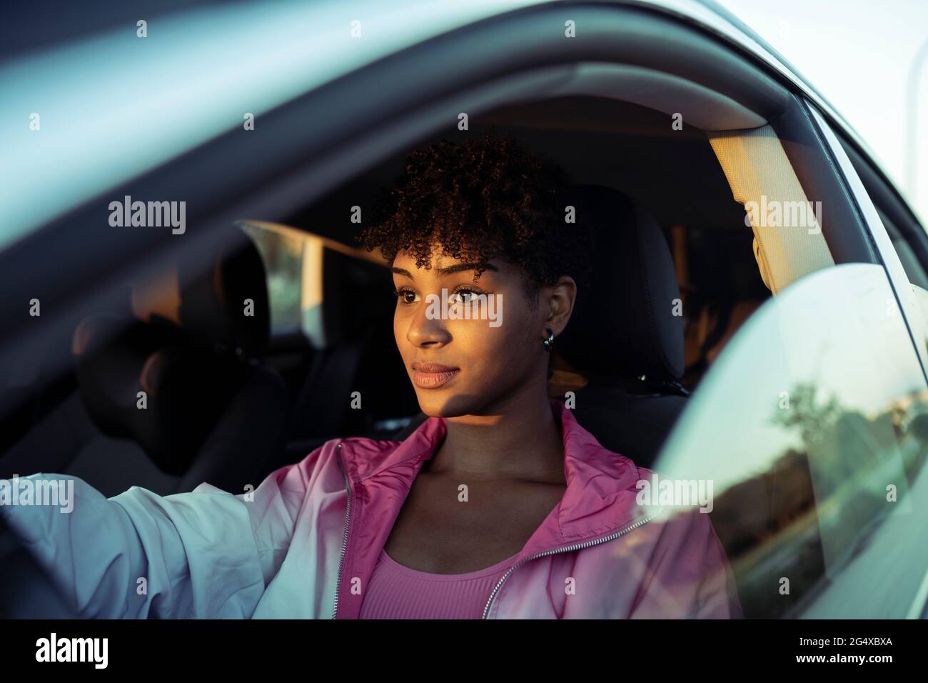 Young woman driving car in sunlight hi-res stock photography and images ...