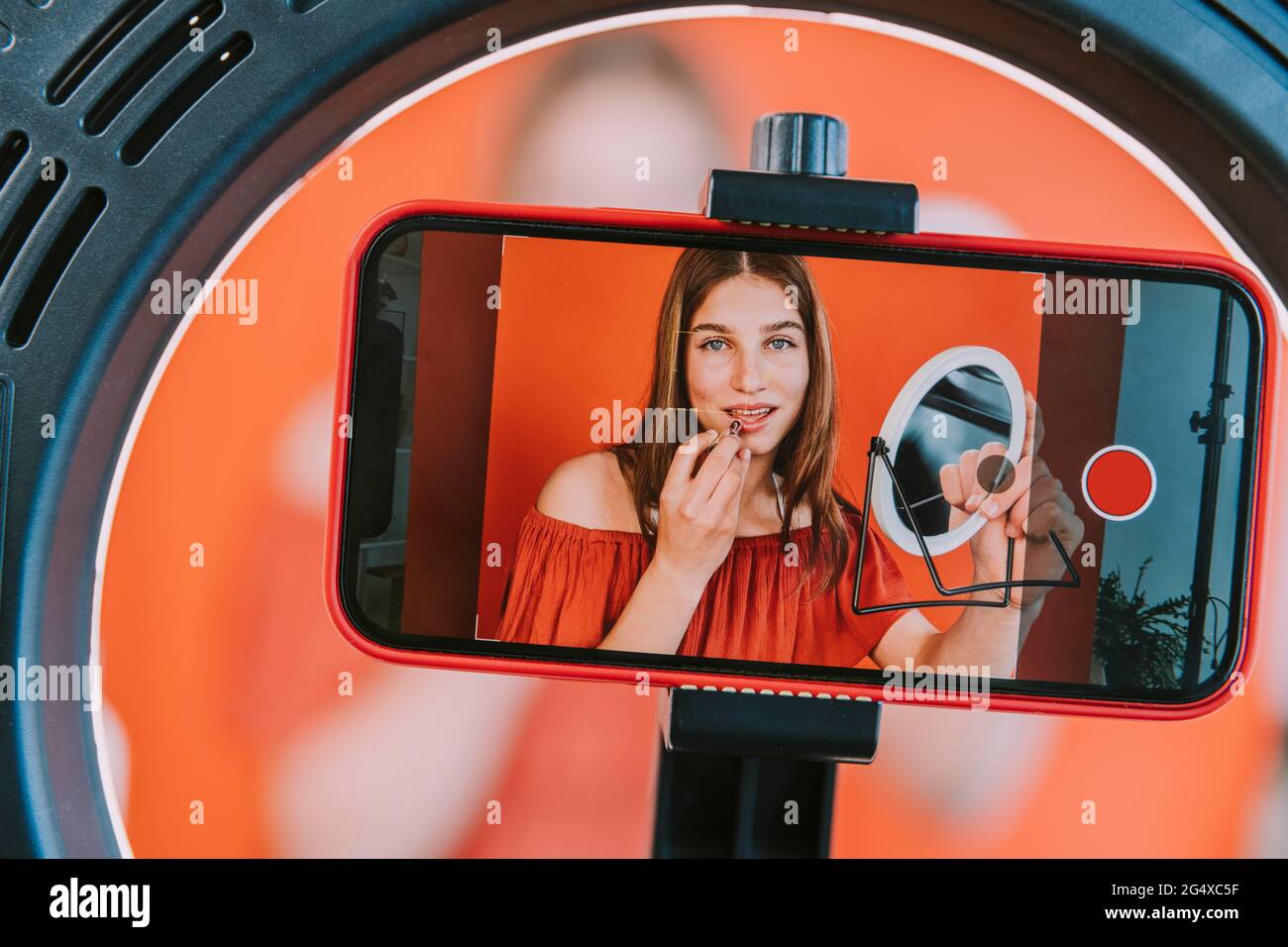 Teenage girl filming make-up tutorial at home Stock Photo - Alamy
