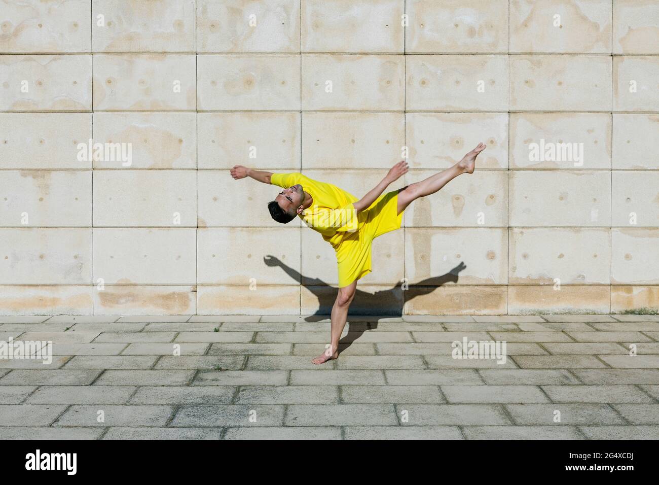Young man practicing dance in front of wall Stock Photo - Alamy