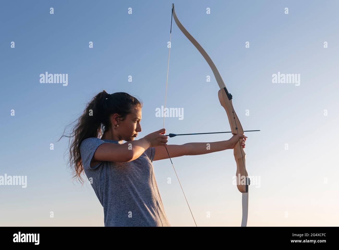 Young female archer practicing archery hi-res stock photography and ...