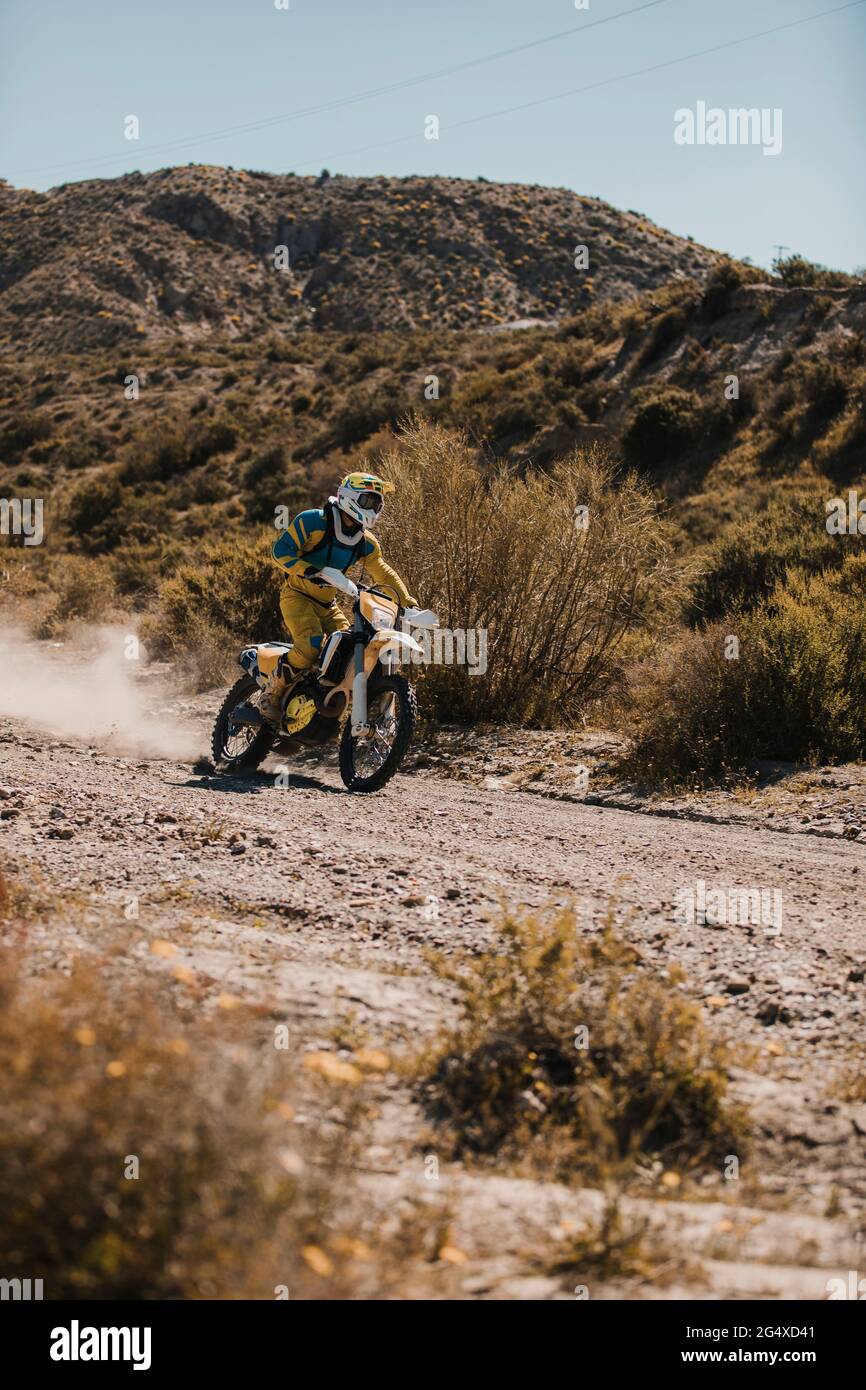 Male biker riding motorcycle at desert during sunny day Stock Photo - Alamy