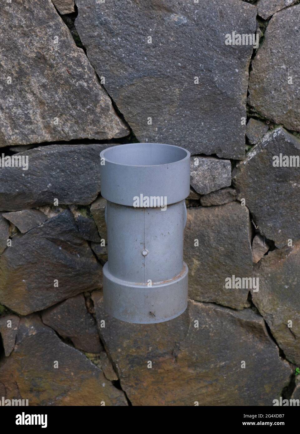 sewer pipe close-up with the stone embankment in the background Stock ...