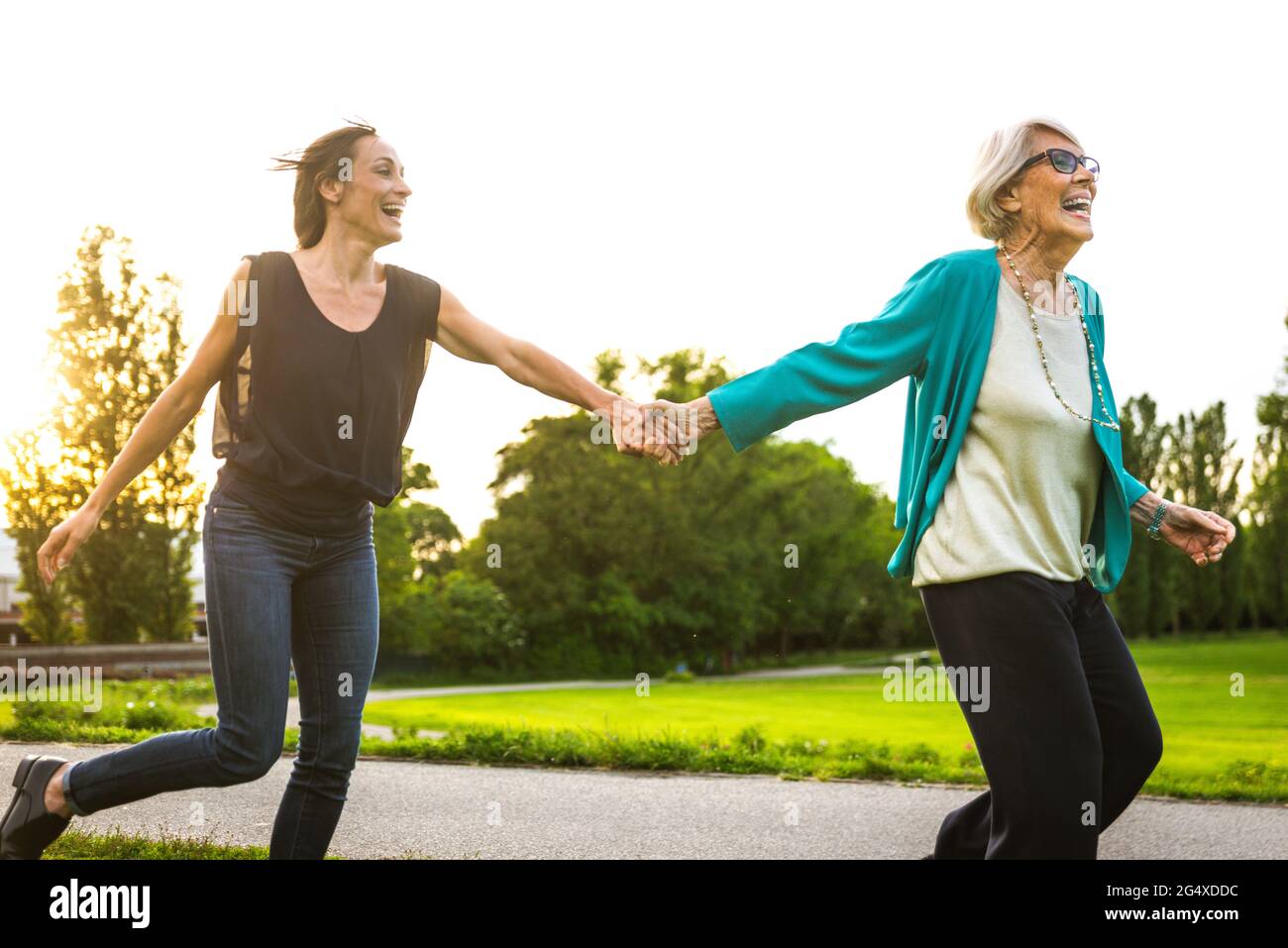 Granddaughter and grandmother running hi-res stock photography and ...