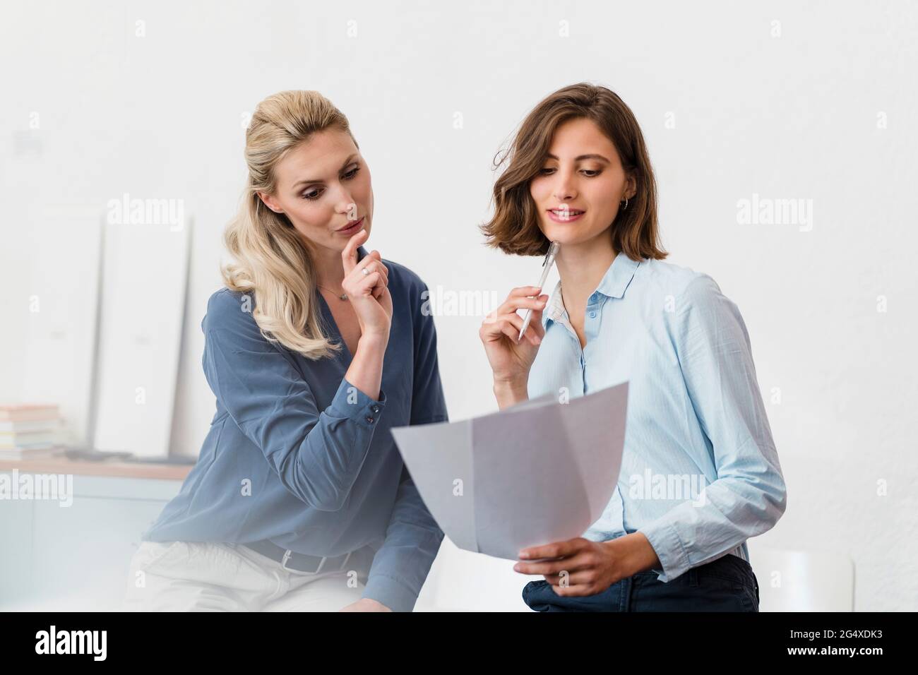 Two young people looking documents hi-res stock photography and images ...
