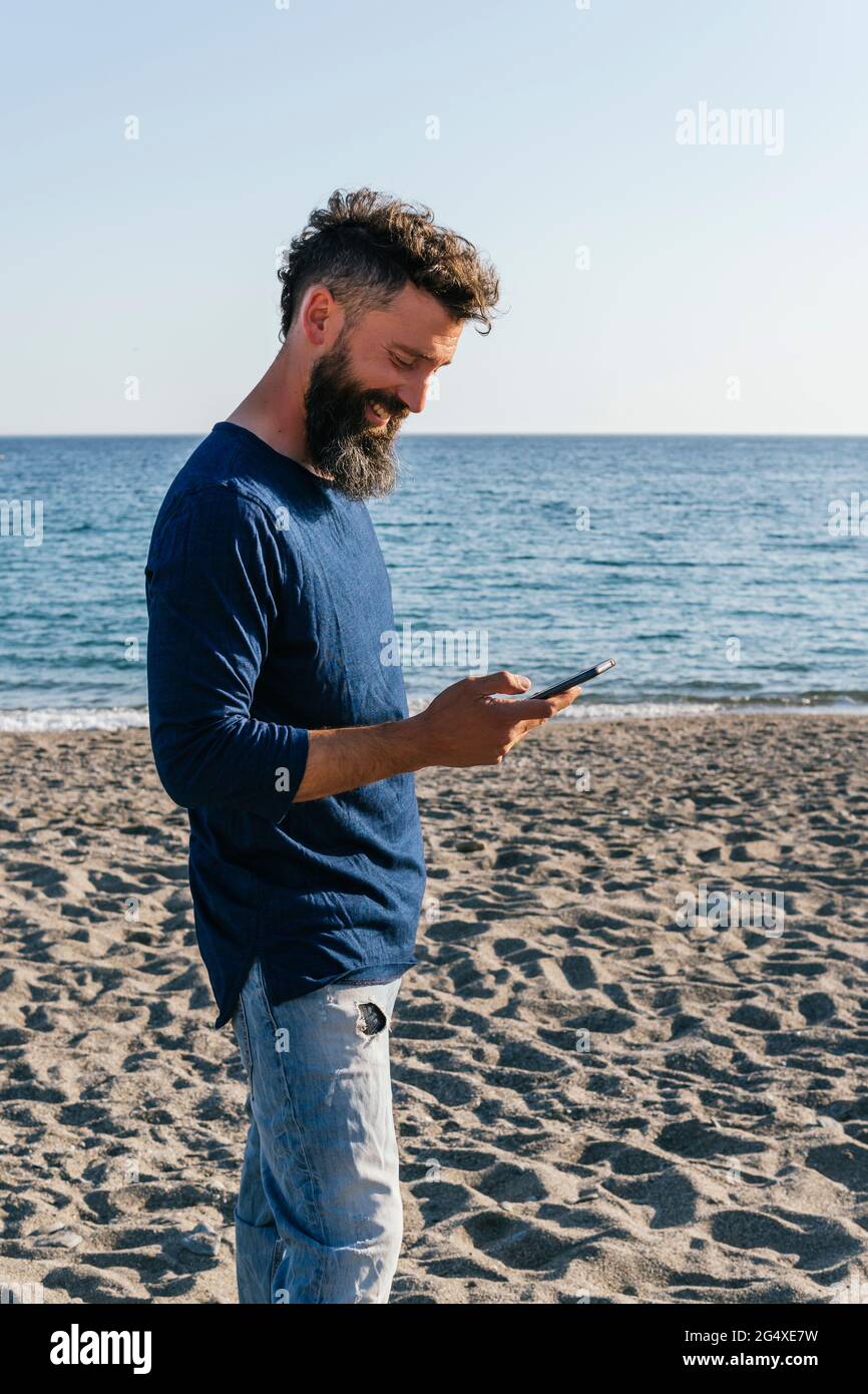 Man standing using phone hi-res stock photography and images - Alamy