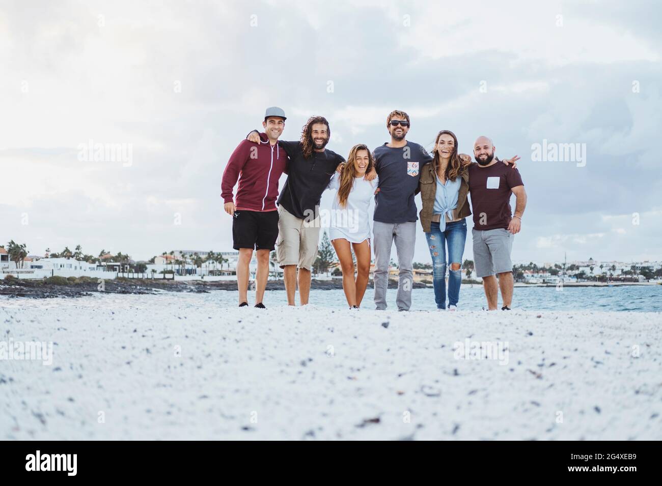 Three male friends standing together hi-res stock photography and ...