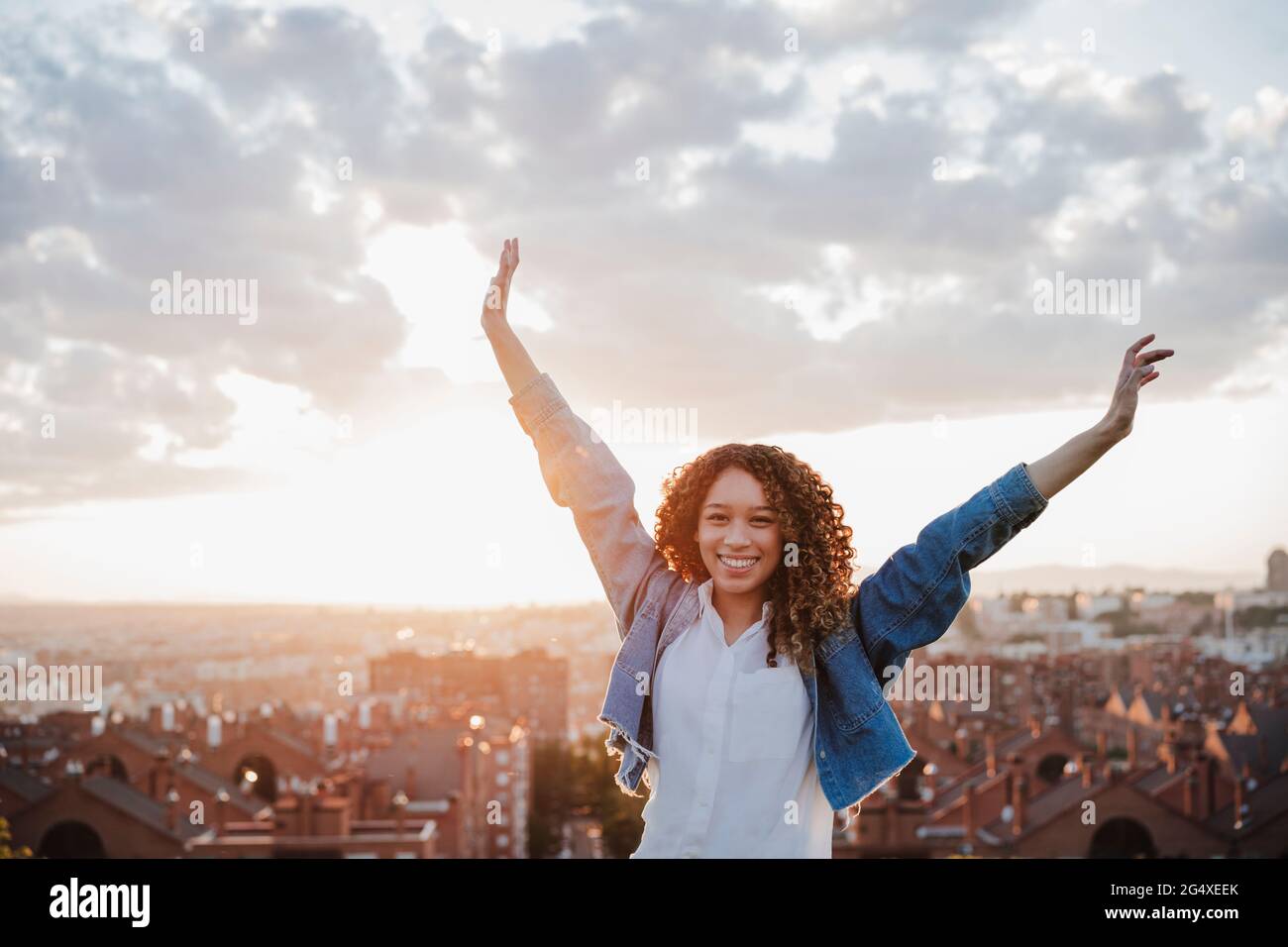 Woman raising arms in hi-res stock photography and images - Alamy