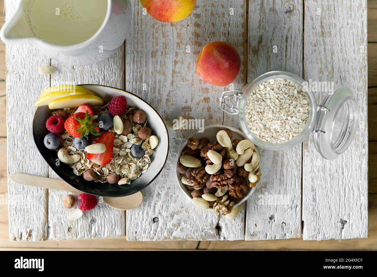 Healthy breakfast: muesli, fruit, milk on rustic wooden tray Stock ...