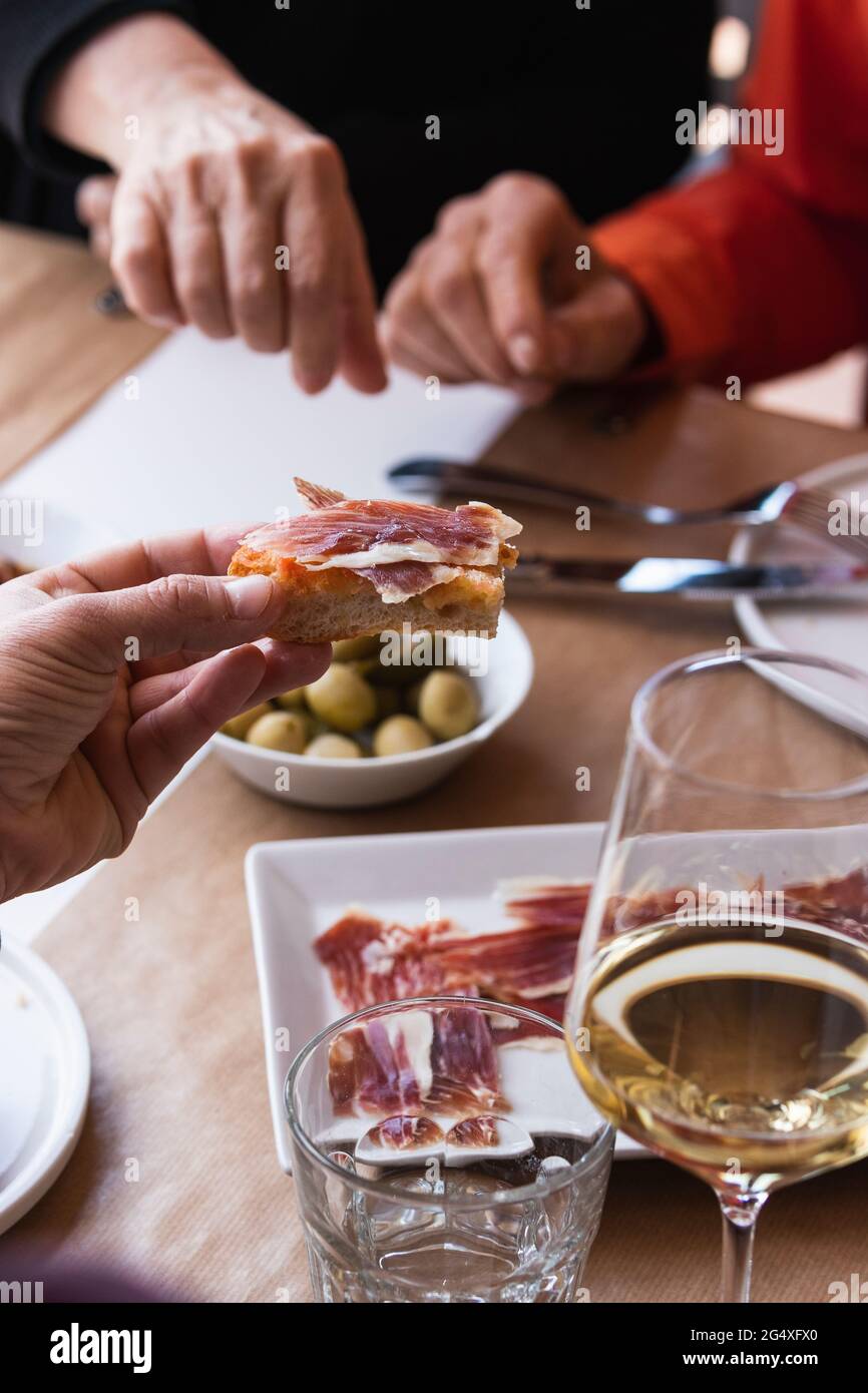 Friends having tapas at table in restaurant Stock Photo - Alamy