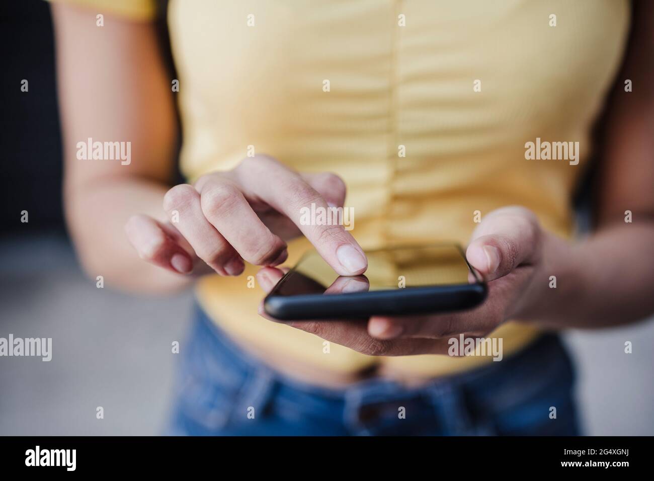 Woman touching screen of smart phone Stock Photo - Alamy