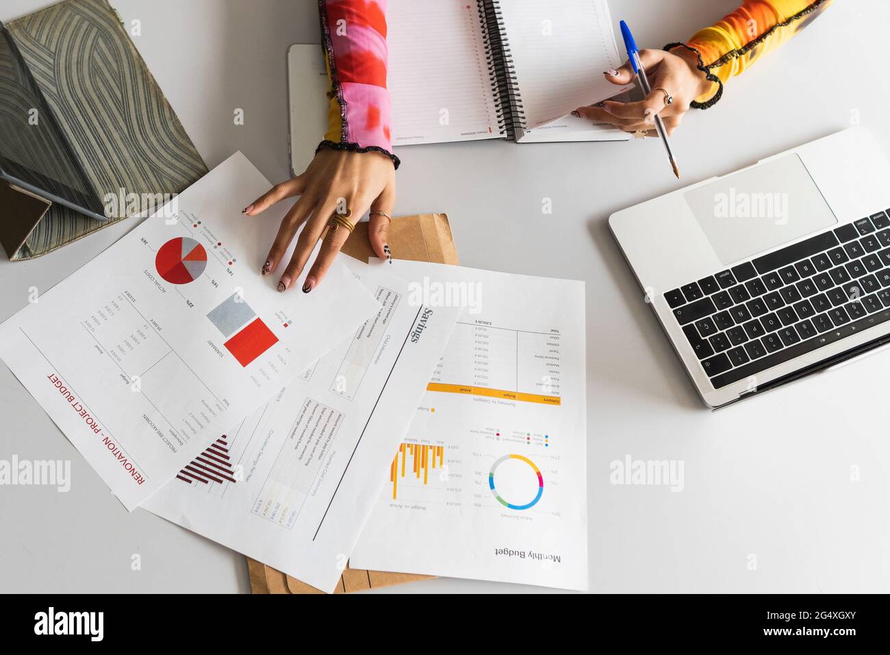 Female student learning finance chart on desk in library Stock Photo ...