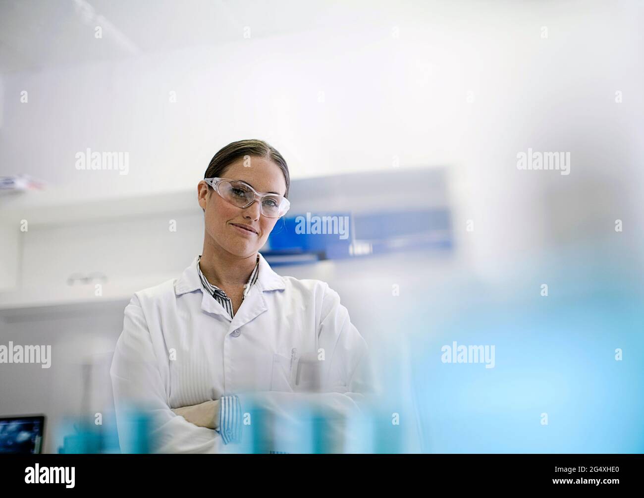 Female lab technician with arms crossed in laboratory Stock Photo - Alamy