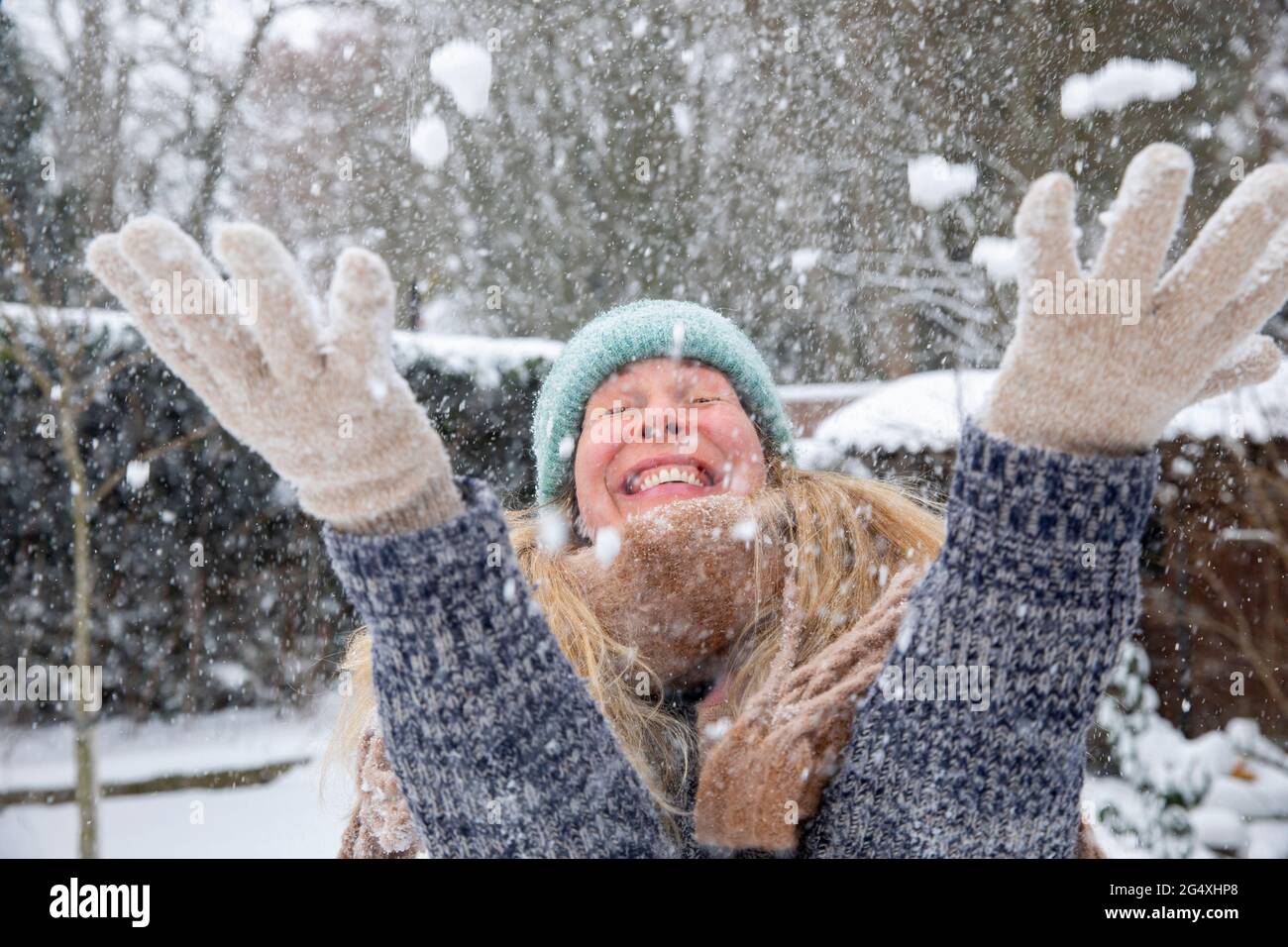 Playful woman throwing snow hi-res stock photography and images - Alamy