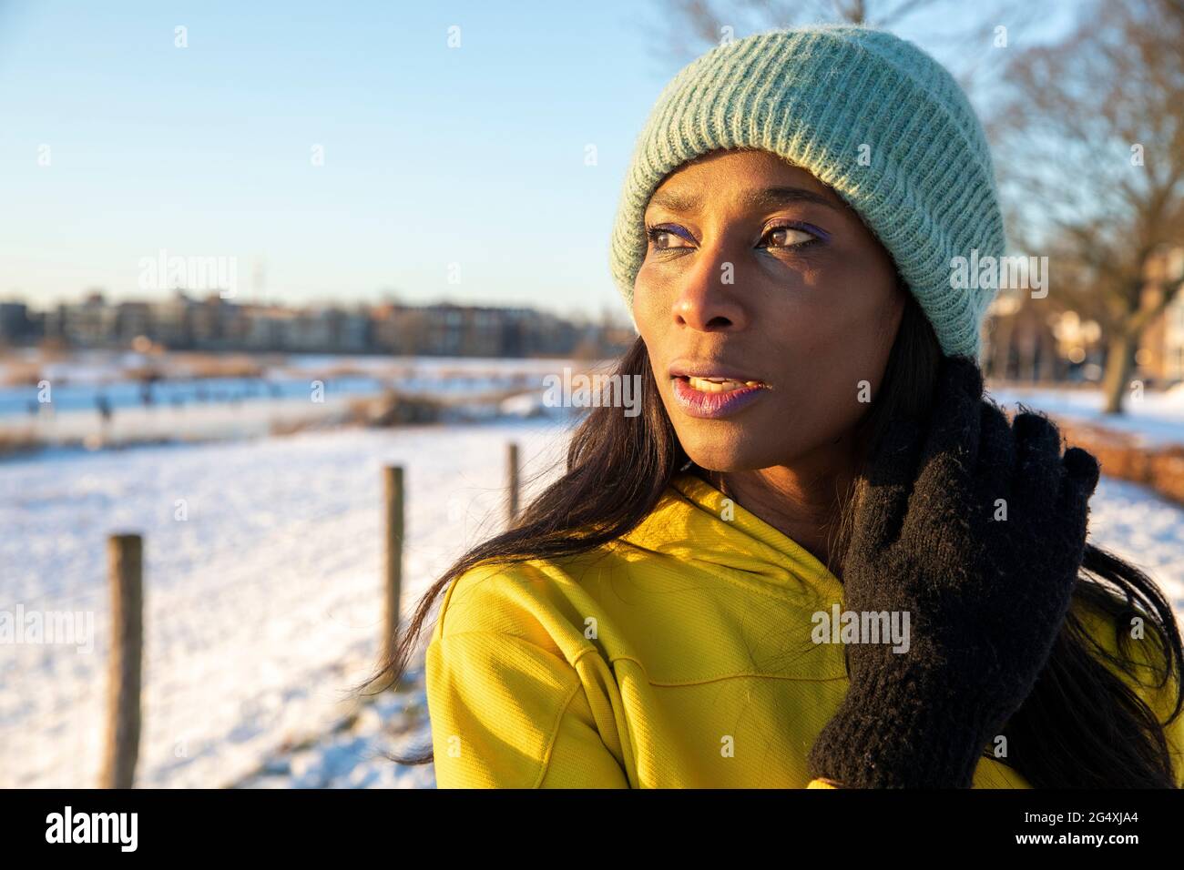 Beautiful mature woman wearing blue knit hat while looking away Stock ...