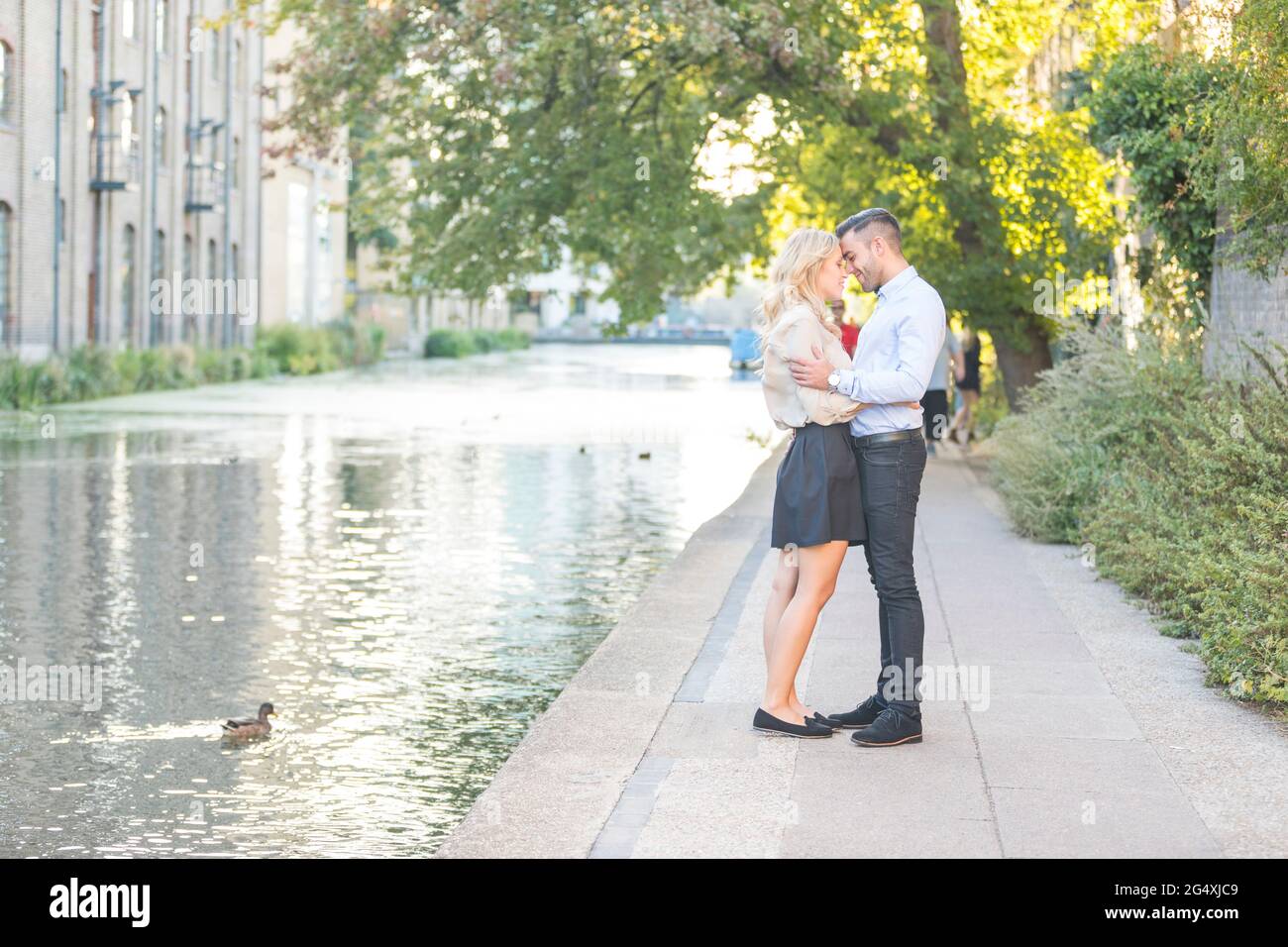 Boyfriend and girlfriend embracing while standing at promenade Stock ...