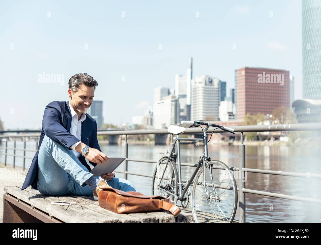 Businessman sitting riverside using hi-res stock photography and images ...