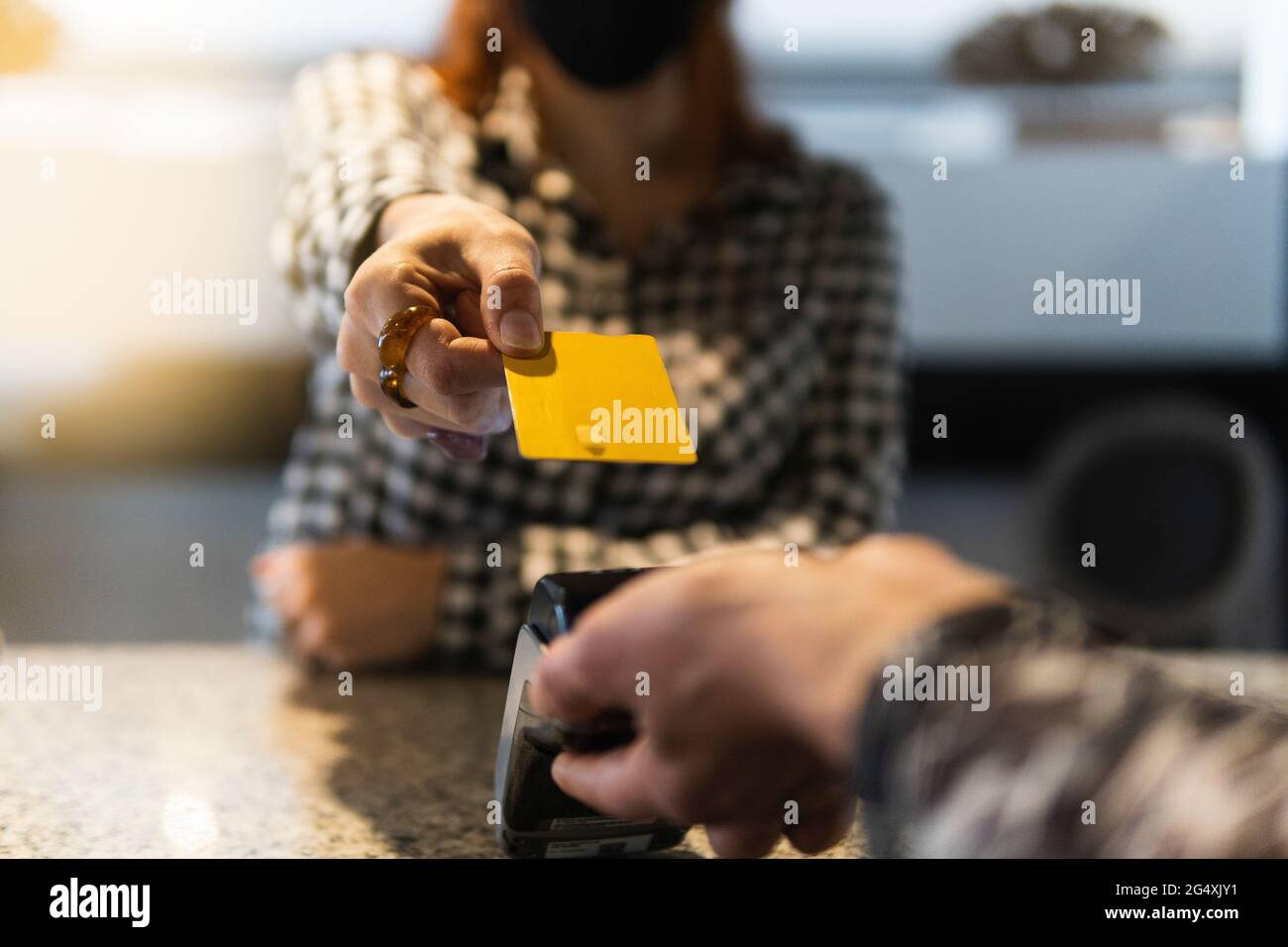 Woman paying through credit card at counter in restaurant Stock Photo ...