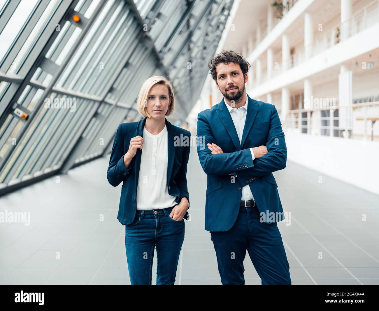 Portrait business partners standing arms hi-res stock photography and images - Alamy