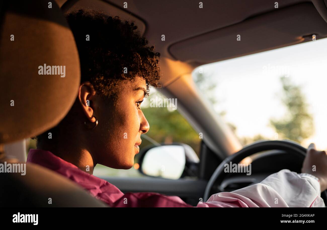 Woman driving car during sunset hi-res stock photography and images - Alamy