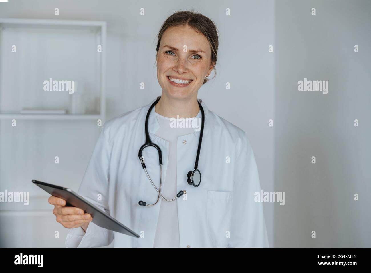 Happy doctor holding up hi-res stock photography and images - Alamy