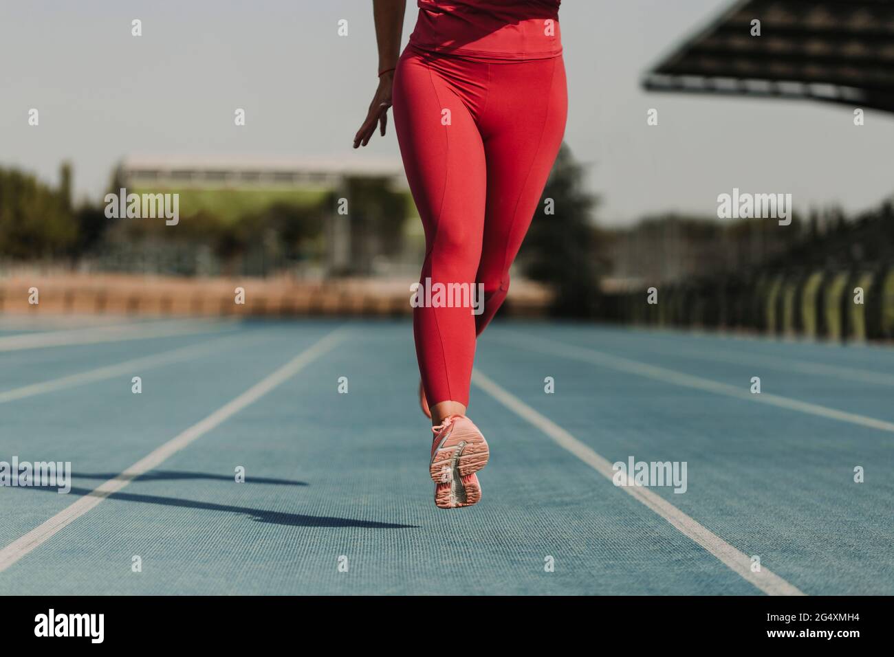 Female athlete running in stadium Stock Photo - Alamy