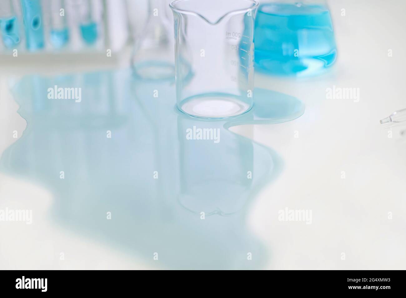 Spilled liquid and glassware on table in laboratory Stock Photo - Alamy