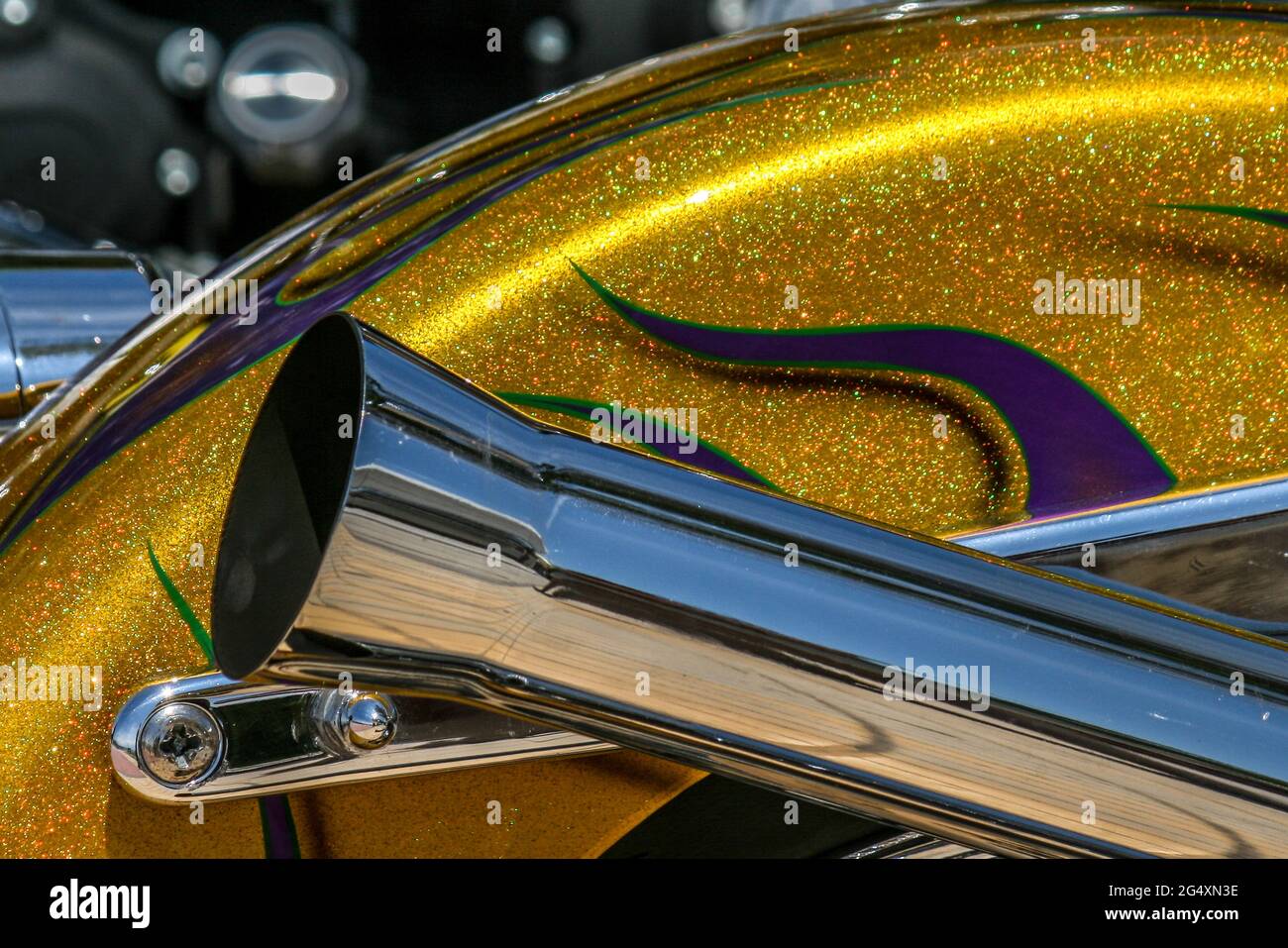 An exhaust pipe and other parts of a golden motorcycle Stock Photo - Alamy