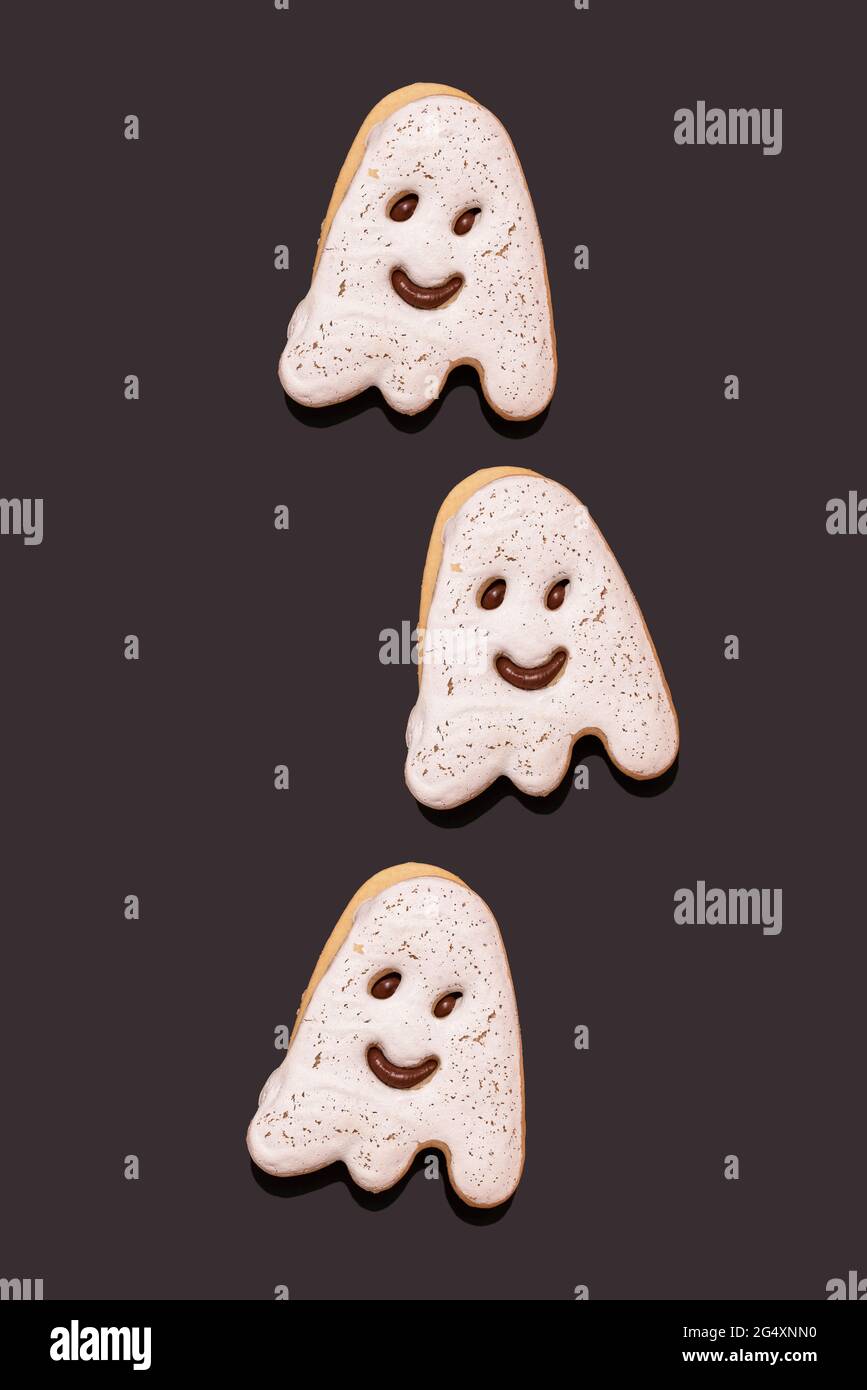 Studio shot of three glazed ghost-shaped chocolate cookies Stock Photo ...