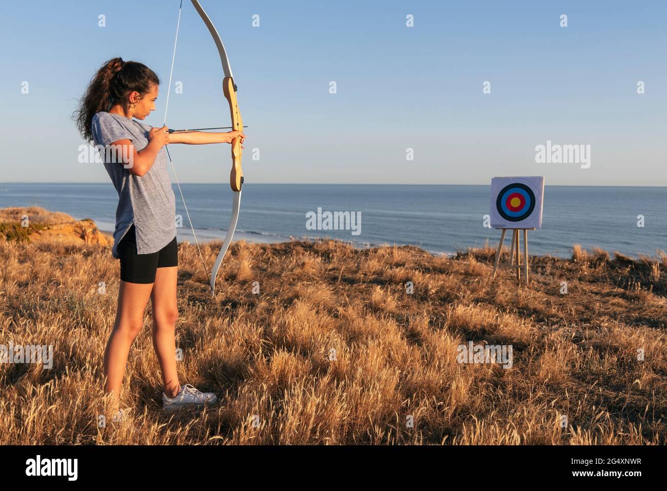 Young female archer practicing archery hi-res stock photography and ...