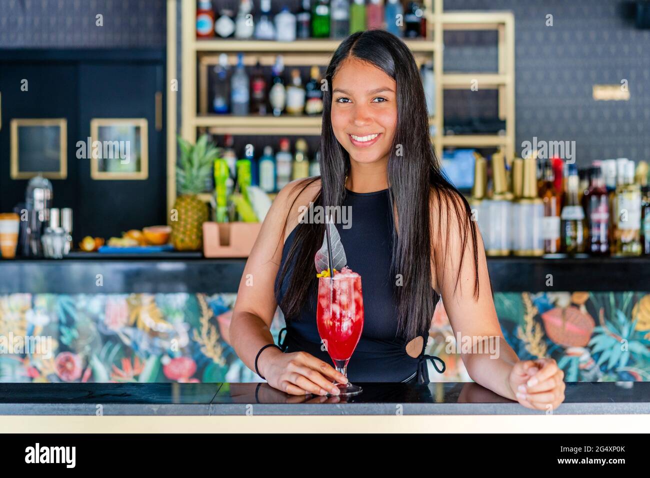 Beautiful woman with cocktail at bar counter Stock Photo - Alamy