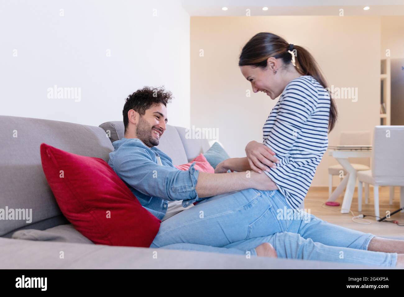 Couple sitting sofa female tickling male hi-res stock photography and ...
