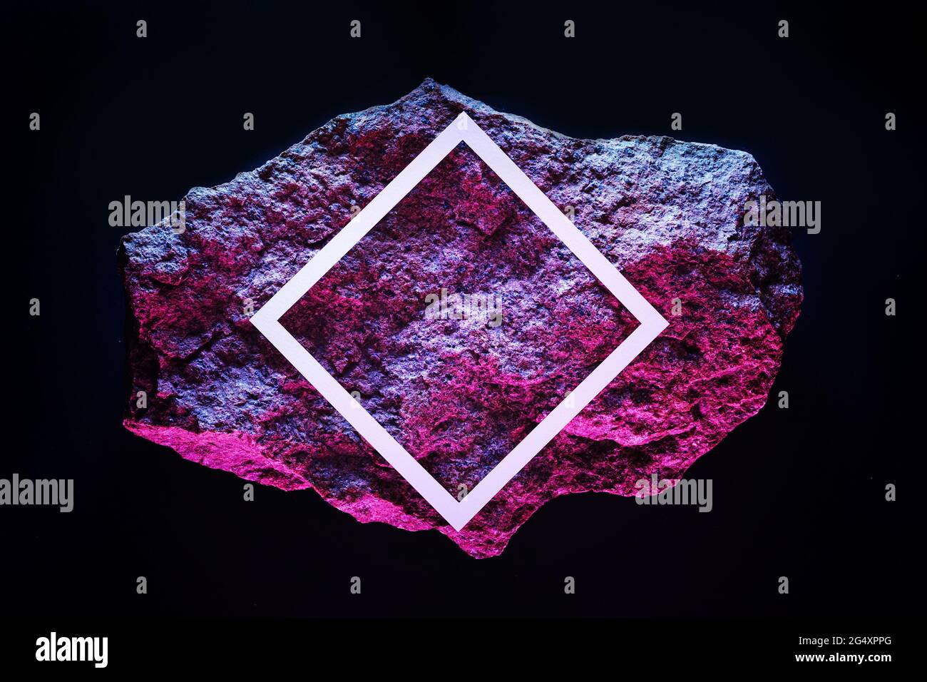 Red meteorite in dark space with white frame and copy space neon ...