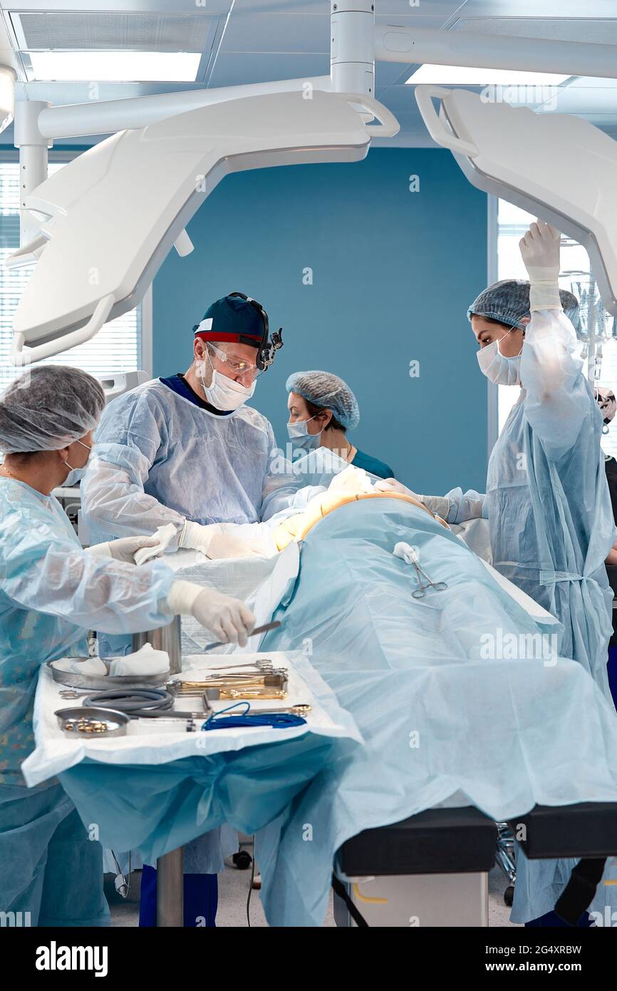 Doctor and surgeon assistant send manual surgical instrument to rescue ...