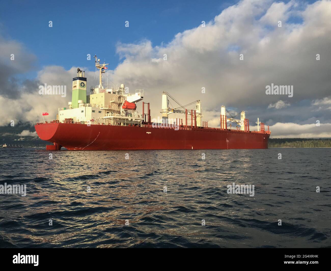 Freight ship cargo vessel at anchor in shore Stock Photo - Alamy