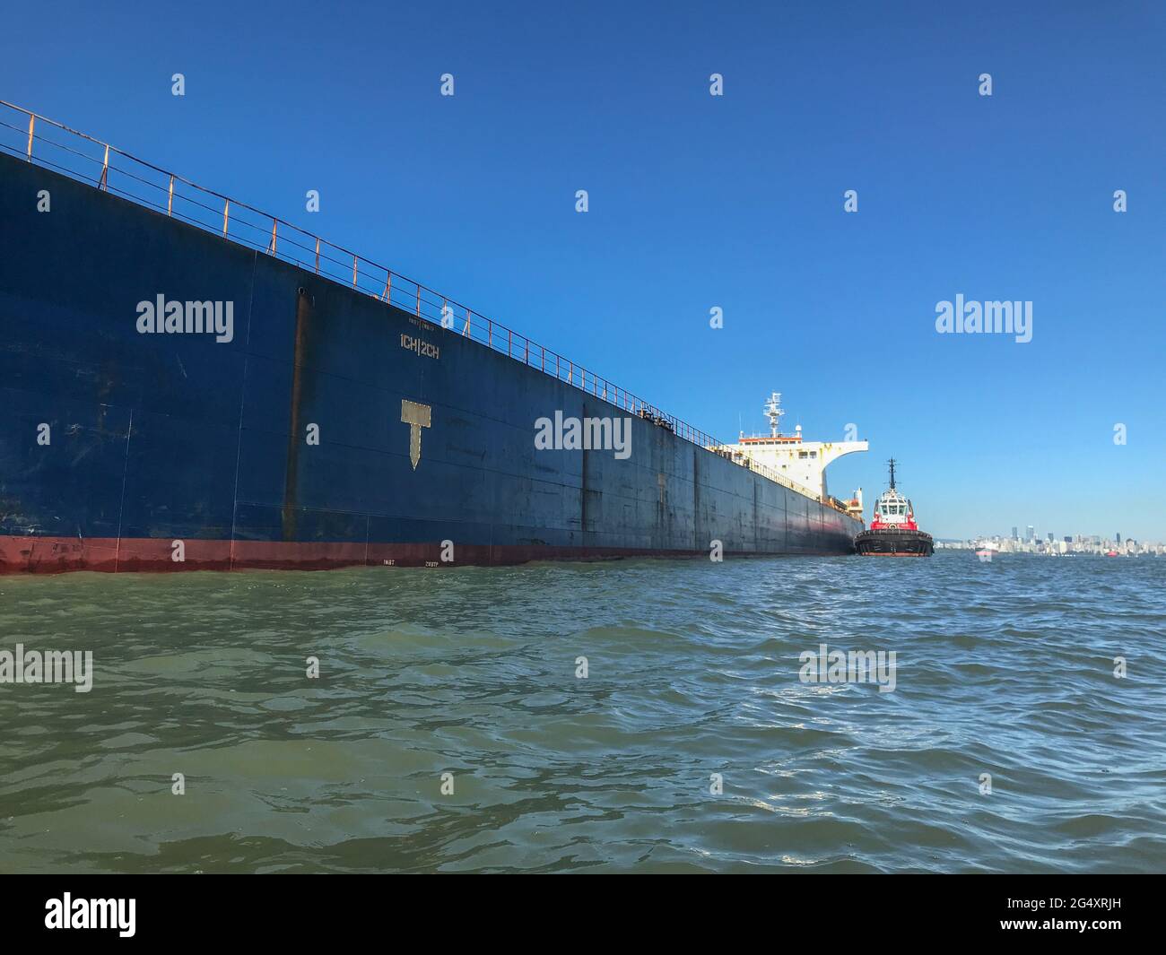Freight ship cargo vessel at anchor in shore Stock Photo - Alamy