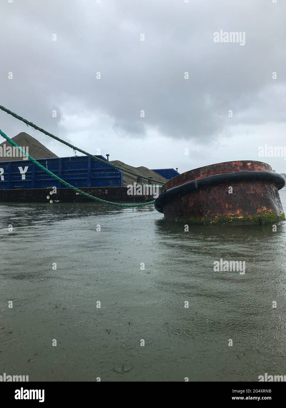 loaded sand barge tied to anchor buoy Stock Photo - Alamy