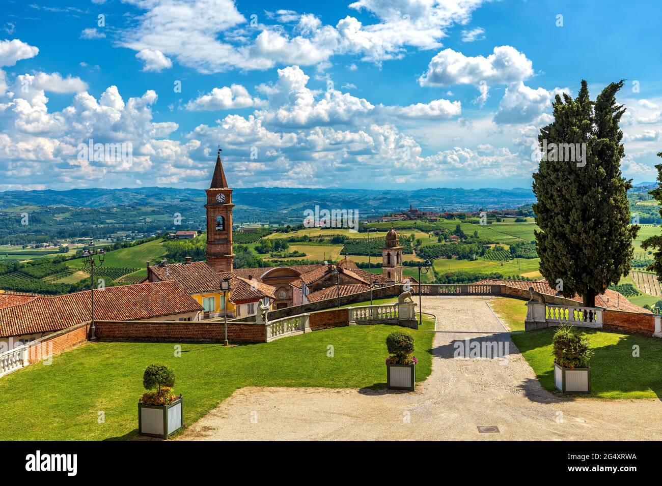 Old town of Govone overlooking green hills under beautiful blue sky ...