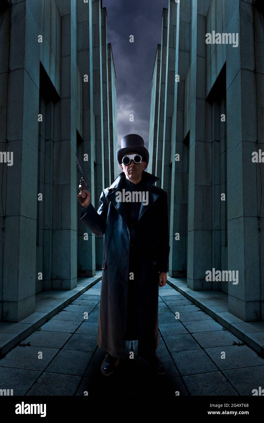 Steampunk man with top hat and goggles holding a colt 45 gun Stock ...