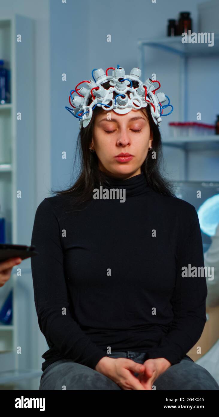 Stressed patient sitting on neurological chair with eeg headset ...