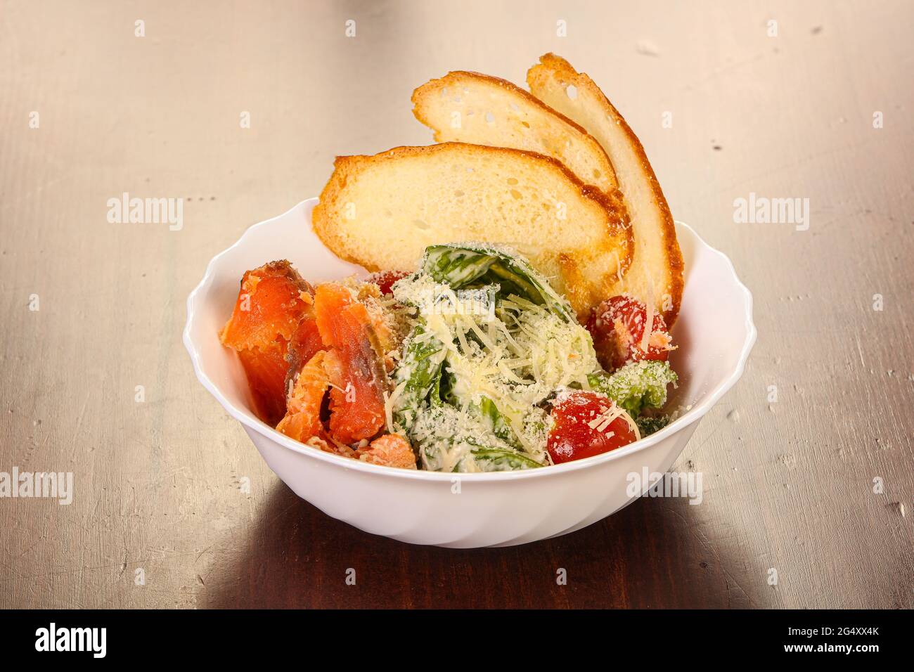 Caesar salad with salmon fish and cheese Stock Photo - Alamy