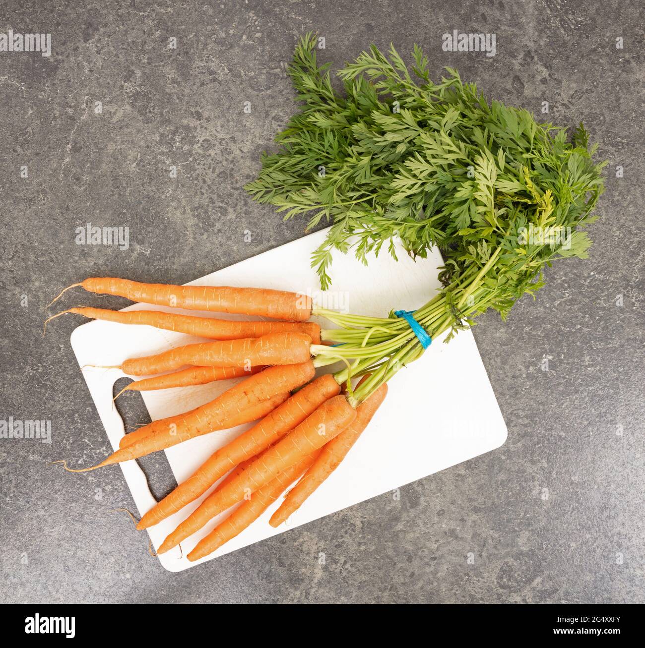 Cutting board with carrots - Concept of food Stock Photo - Alamy
