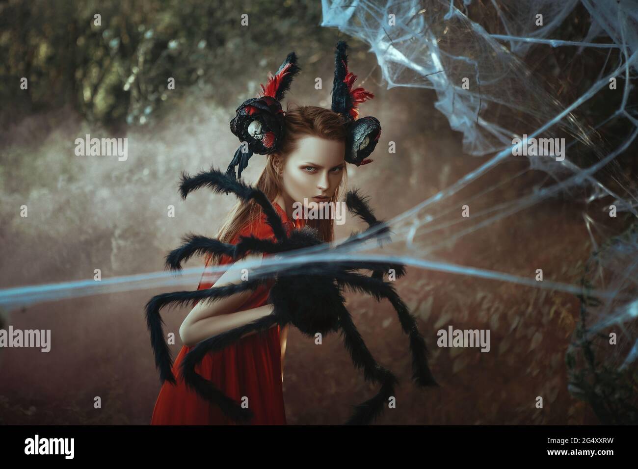 The young model is posing as a fairy in a spiderweb Stock Photo - Alamy