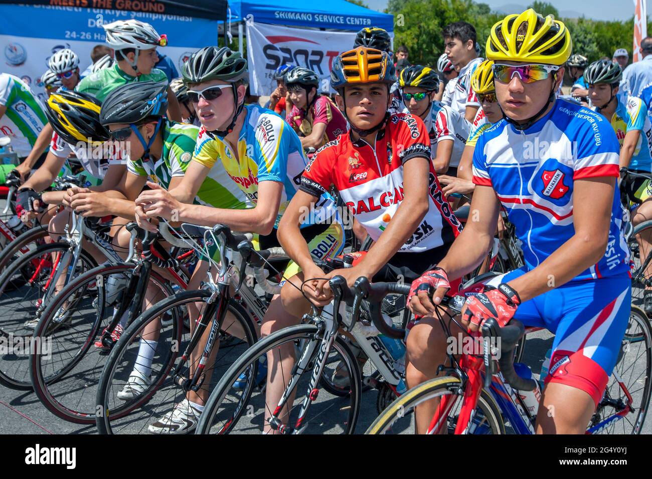 Junior male cyclists wait at the starting line for their race to begin ...